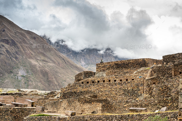 Old Incan castle from stone on mountain background Stock Photo by tan4ikk