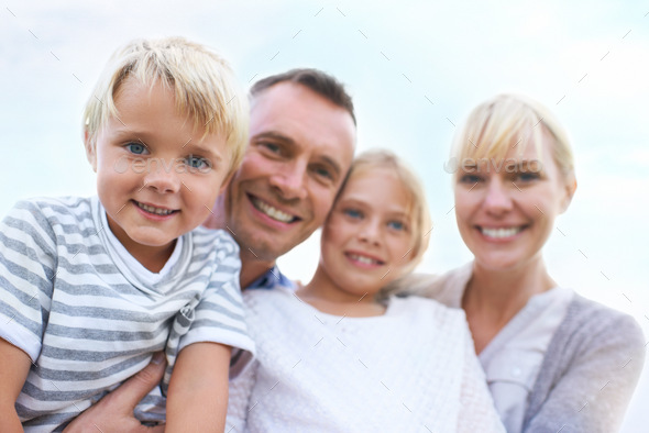 Theyre such a happy family. A happy two generation family smiling while ...