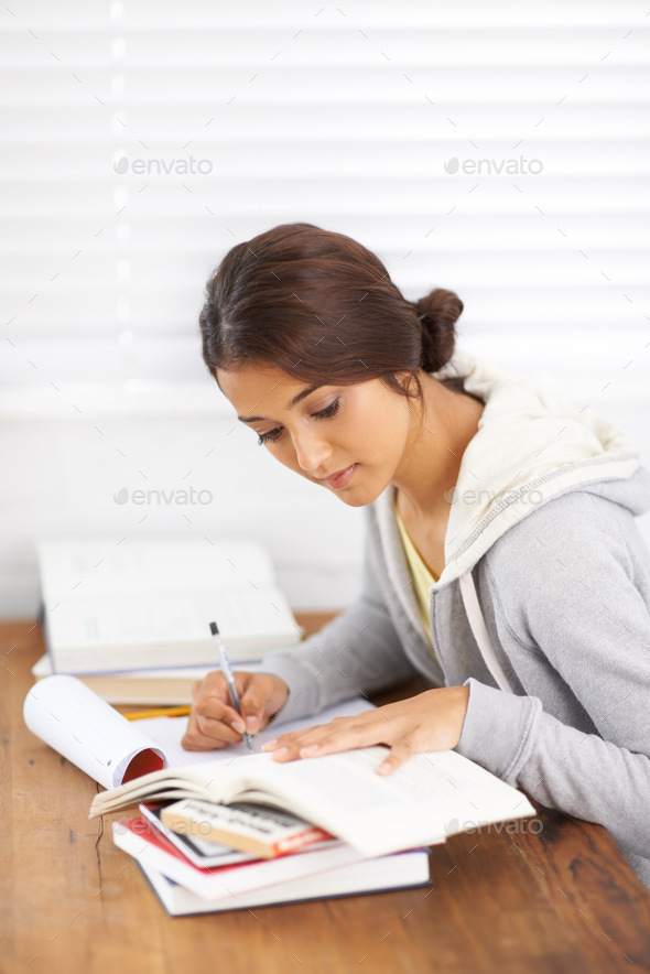 Taking down spark notes. Side view of a young college student taking ...
