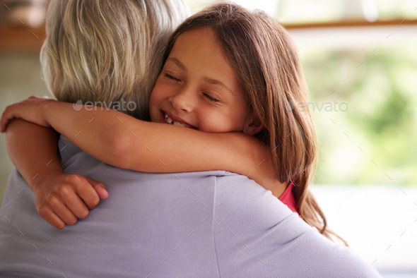 Giving granny a big hug. Shot of a cute little girl hugging her ...