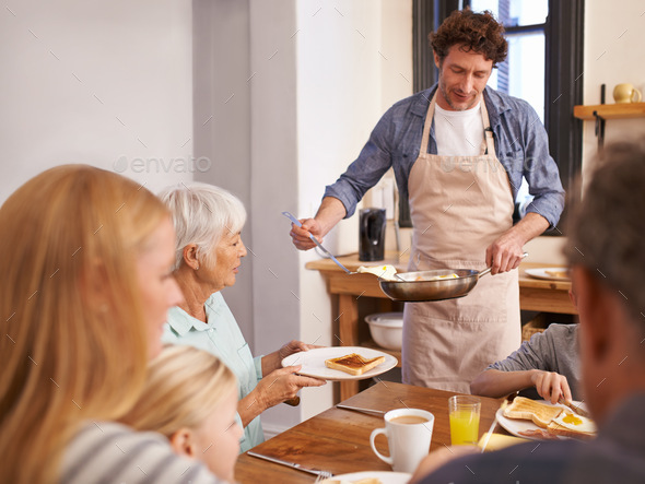 Just one for me, please. A cropped shot of a man serving his family a ...