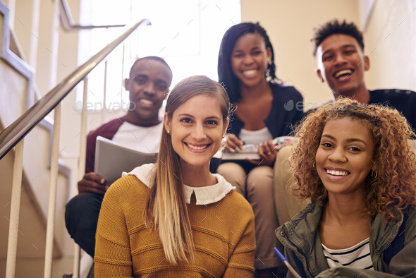 Cropped portrait of a group of young university students sitting on ...