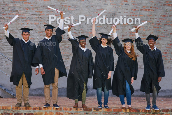 Portrait of a happy group of students standing with their diplomas on ...