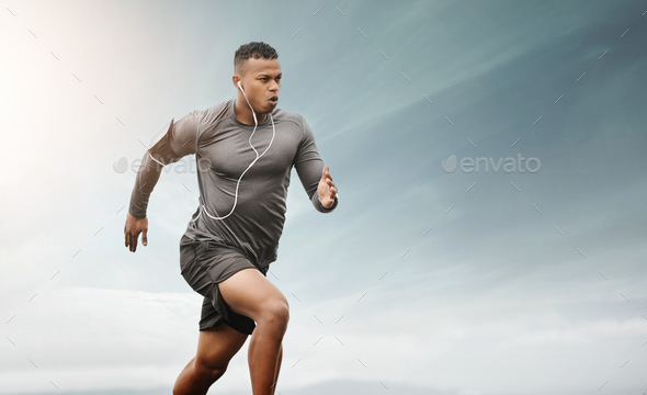 Progress comes with determination. Shot of a sporty young man running ...