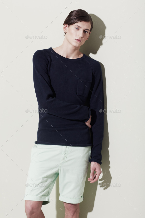 A handsome young man with elegant facial features posing for a studio ...