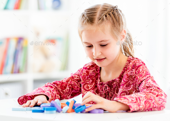 Little girl solving task at school Stock Photo by tan4ikk | PhotoDune