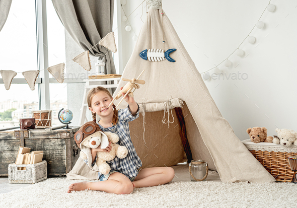 Happy little girl flying wooden plane Stock Photo by tan4ikk | PhotoDune