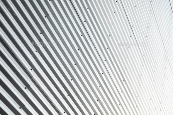 Building with ribbed metal wall with sunlight on the right Stock Photo ...