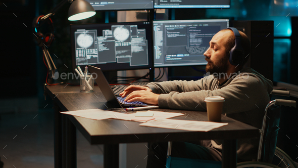 Young programmer typing source code in office Stock Photo by DC_Studio