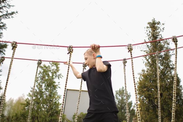 the boy goes through an obstacle course, goes in for active sports ...