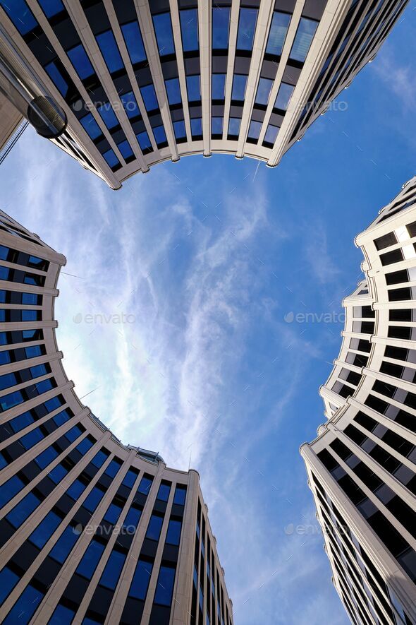 Low angle shot of urban circular round buildings with windows under ...