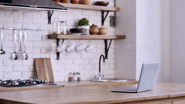 Interior design of laptop on kitchen desk with white brick wall and ...