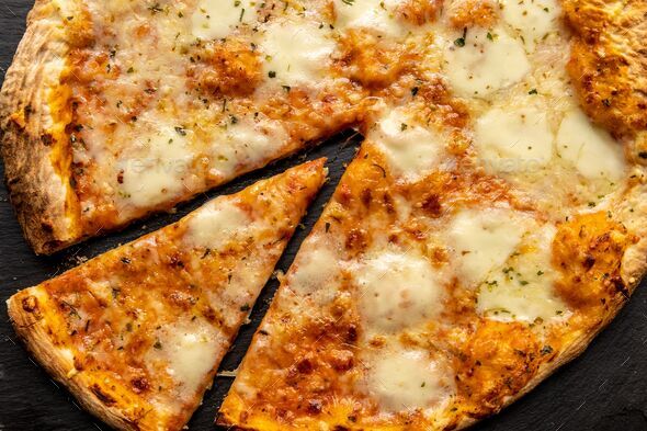 Top view shot of a round cheese pizza on a dark table Stock Photo by ...