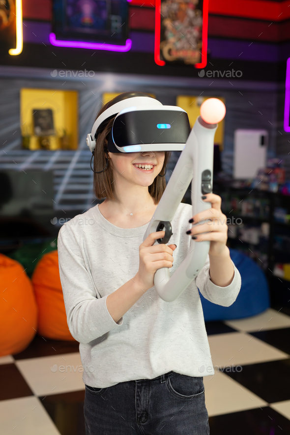 Child, a teenage girl playing on a game console in virtual reality ...