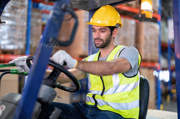 Forklift Truck Operator Lifts Pallet Cardboard Boxes On a Shelf by ...
