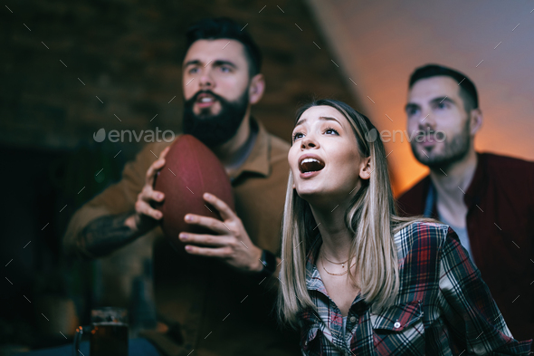 Excited sport fans watching rugby match on TV at home. Stock Photo by ...