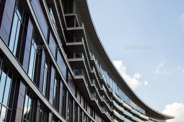 Side-view of fragment of modern glass building with windows and ...