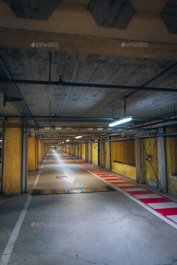 Vertical shot of a parking deck with arrows, speed bump, and signs ...