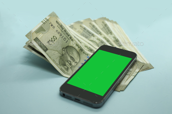 Indian currency - 500 rupee notes and the phone with green screen on ...
