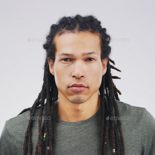 Studio portrait of a handsome young man posing expressionless against a ...