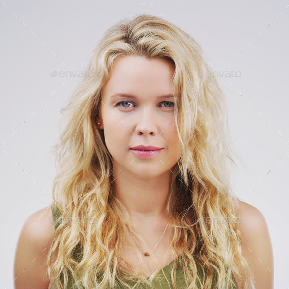 Studio portrait of an attractive young woman posing expressionless ...