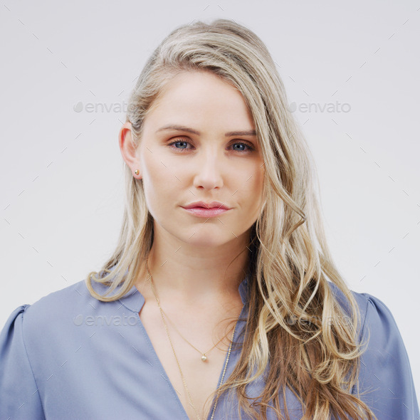 Studio portrait of an attractive young woman posing expressionless ...