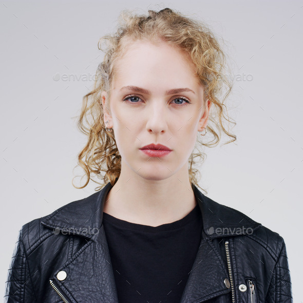 Studio portrait of an attractive young woman posing expressionless ...