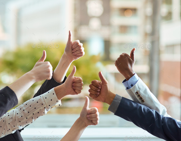 Exceptional work. Cropped shot of a group of businesspeople showing a ...