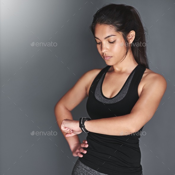 Getting more fit by the day. Shot of a fit young woman in sports ...