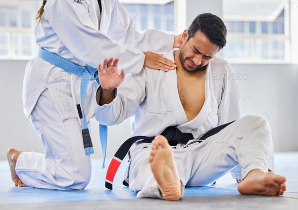 Karate, sports and neck injury pain of fighter on floor with surrender ...
