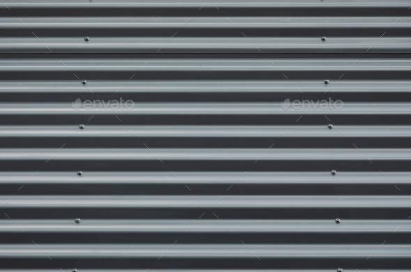 Close-up of ribbed iron wall with bolts Stock Photo by traimakivan