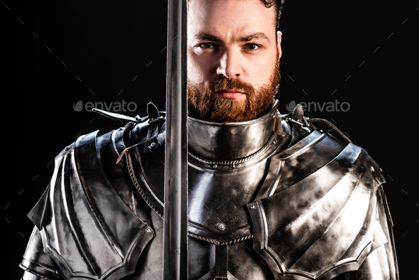 handsome knight in armor holding sword isolated on black Stock Photo by ...