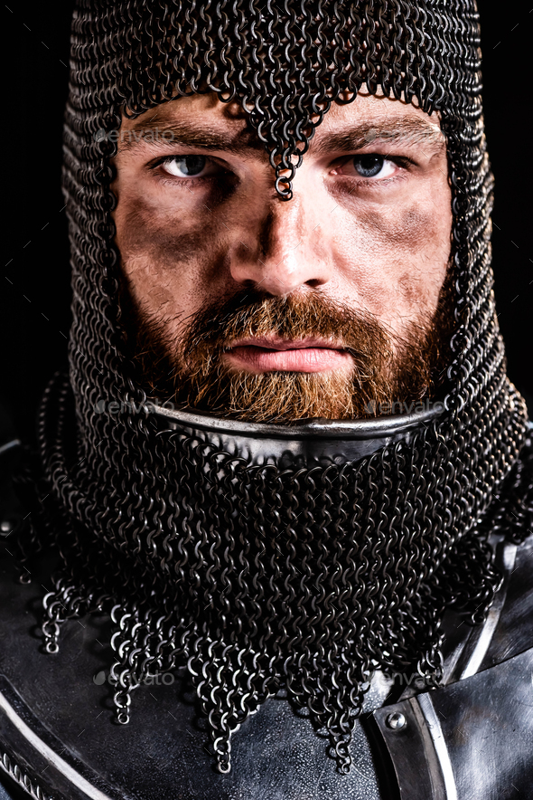 handsome knight in armor looking at camera isolated on black Stock ...