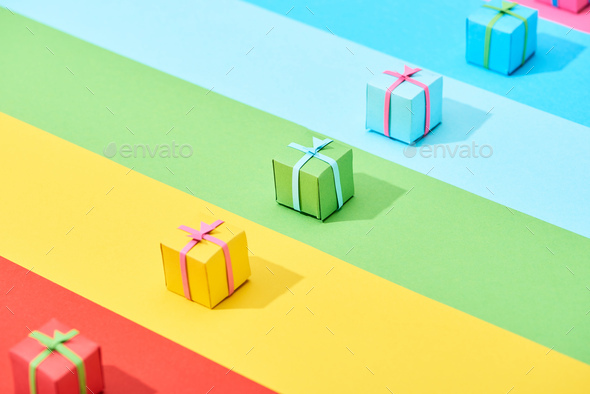 multicolored gift boxes on rainbow background Stock Photo by ...