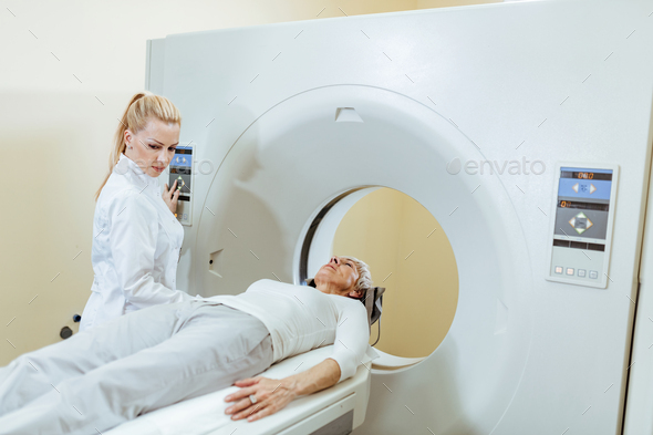 Female senior patient and radiologist during MRI scan procedure at ...