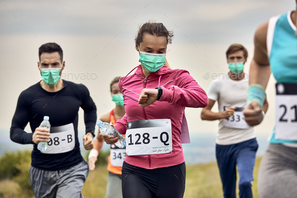 Marathon runner using smart watch while participating in a race. Stock ...