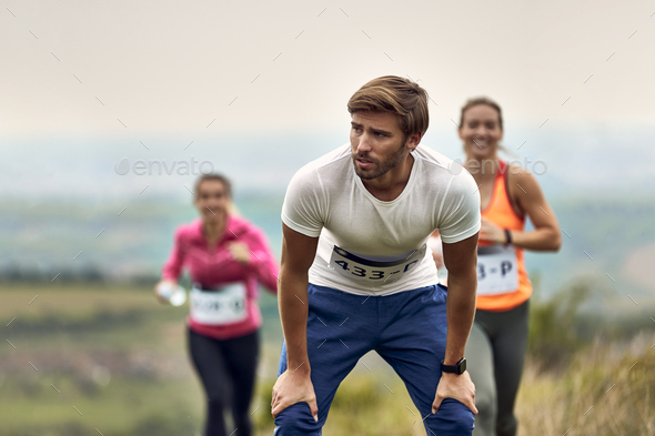 Young marathon runner catching breath after the race in nature. Stock ...
