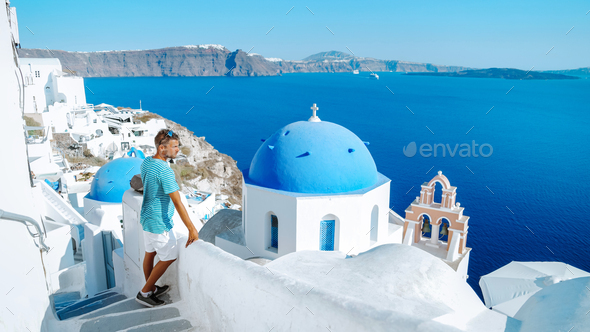 Santorini Greece, young men on vacation at the Island of Greece ...