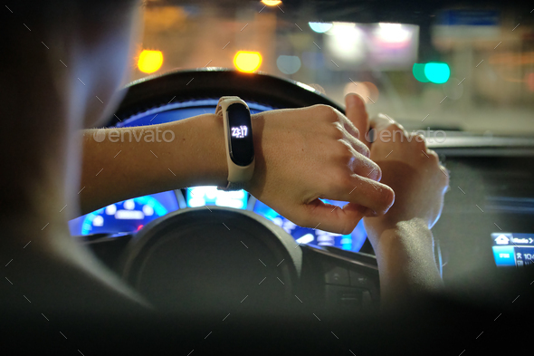 Close up of driver hand with digital watch checking time holding ...