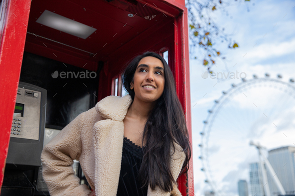 Portrait of a girl in London smiling in a telephone box Stock Photo by ...