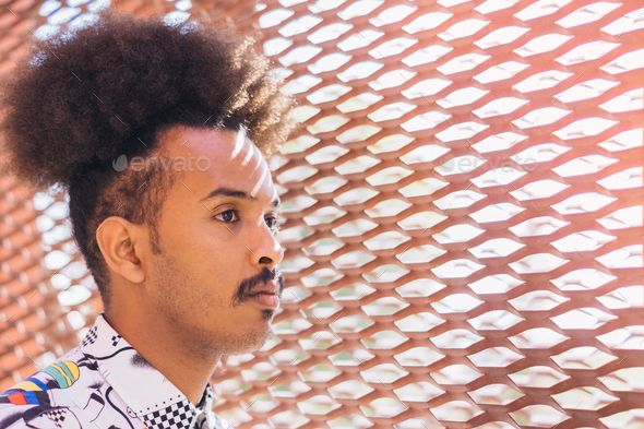 horizontal image of black guy with afro hair collected against metallic ...