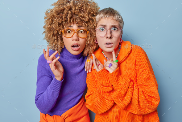 Scared shocked women being best friends stare with disbelief hold ...