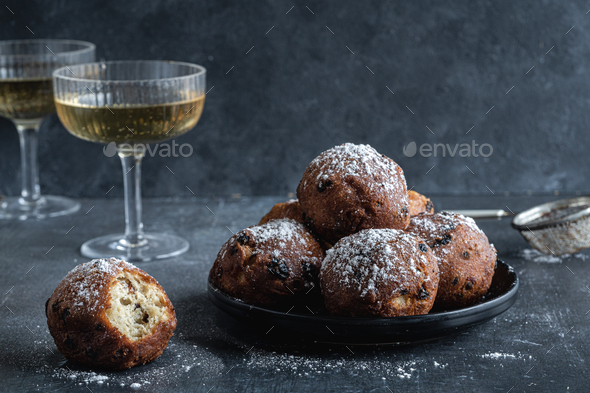 A stack of traditional oliebollen with a glass of champagne Stock Photo ...