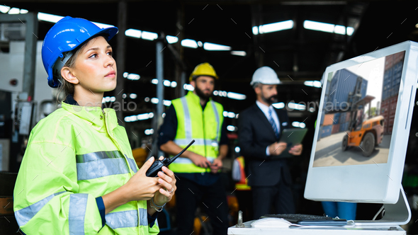 Mechanical engineer woman holding radio working industry wearing safety ...