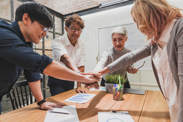 Business people team put hand up group together for unity and cooperate ...