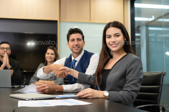 New business people in the conference room are exchanging information ...