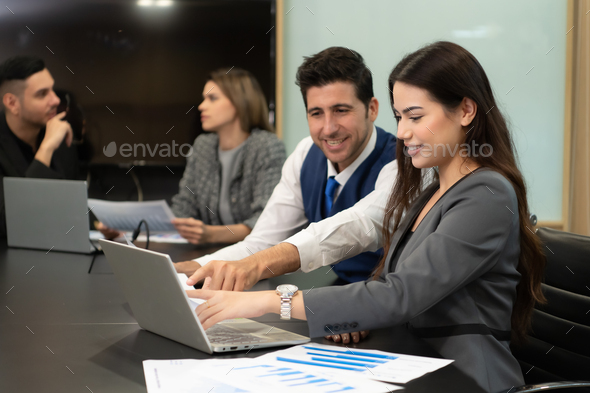 New business people in the conference room are exchanging information ...