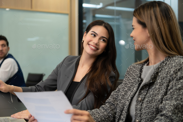 New business people in the conference room are exchanging information ...