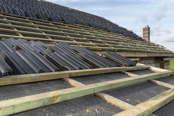 Roof ceramic tile arranged in packets on the roof on roof battens ...