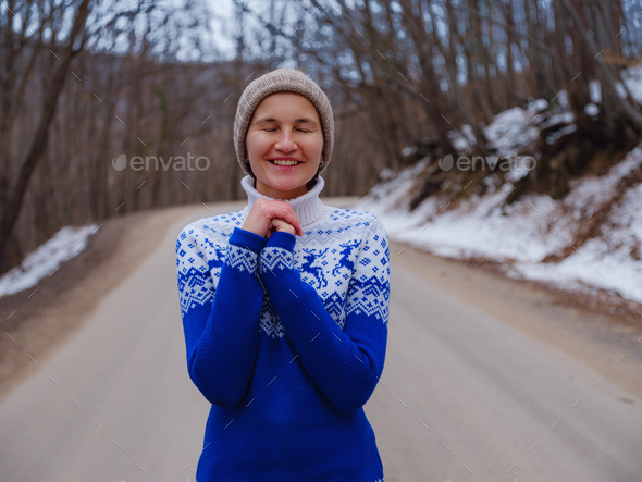Beautiful woman standing among trees in winter forest Stock Photo by ...